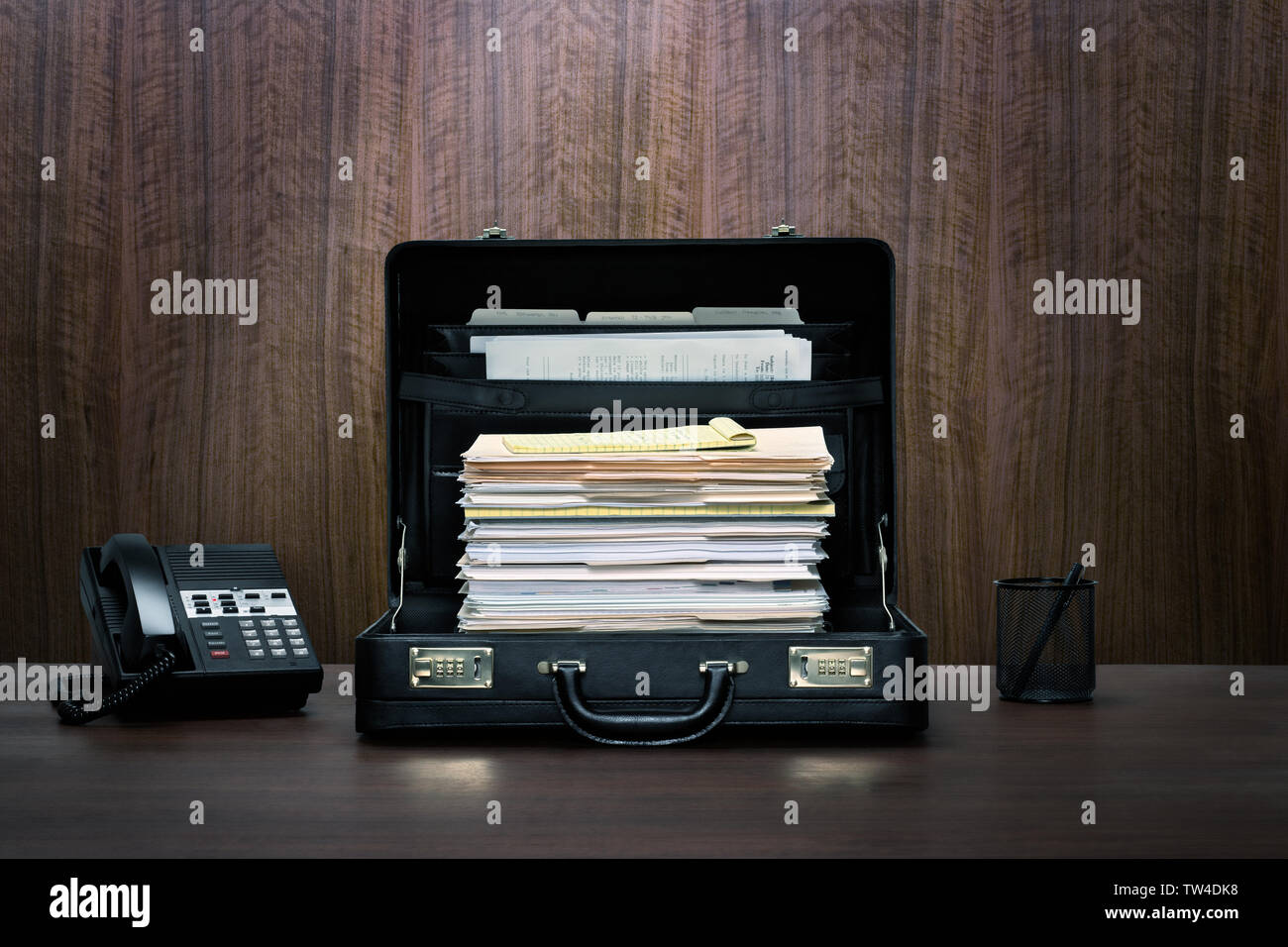Ambitious and overworked, tall stack of files and folders in black ...