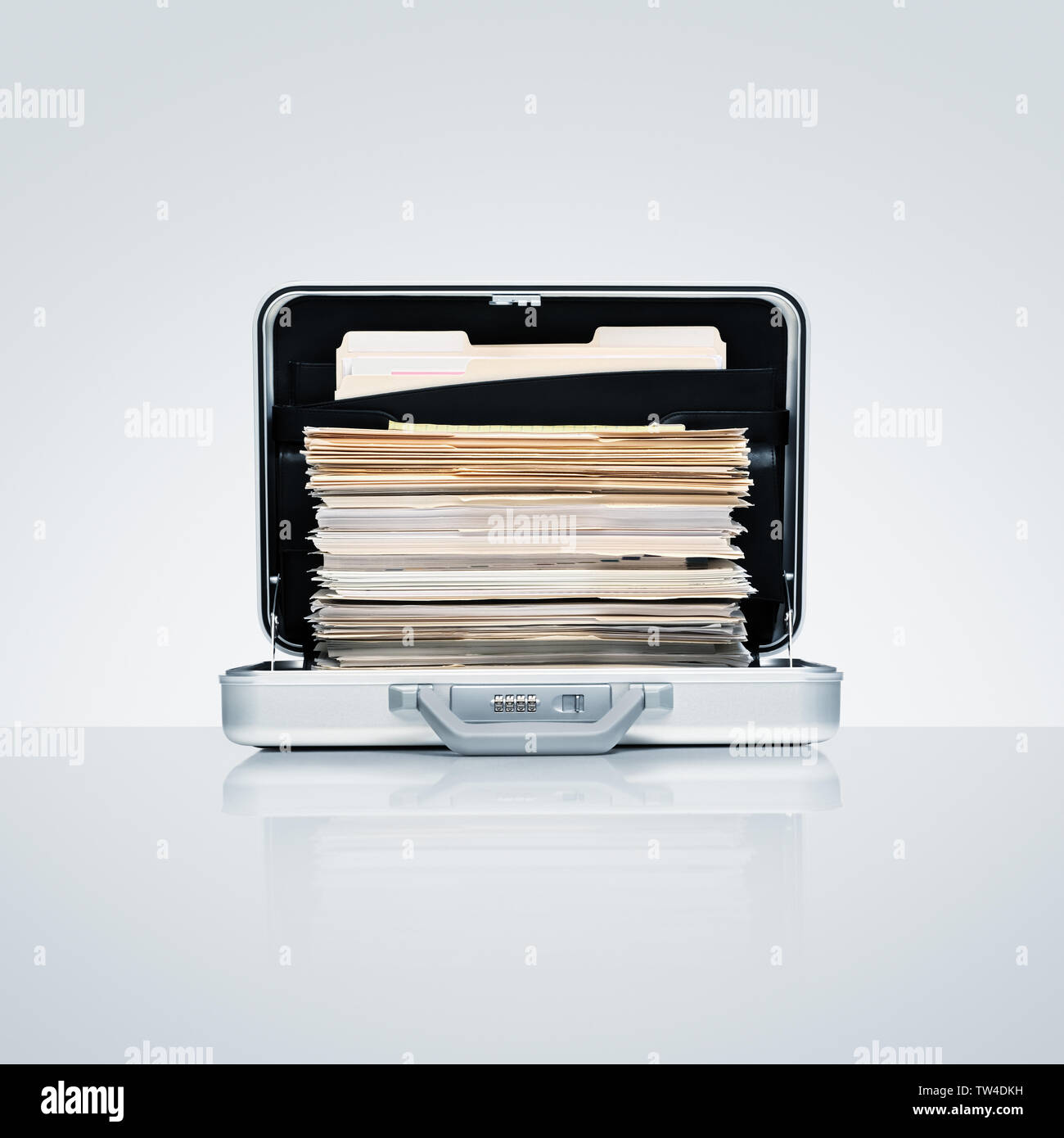 Aluminum briefcase with ambitious stack of files and folders on cool ...