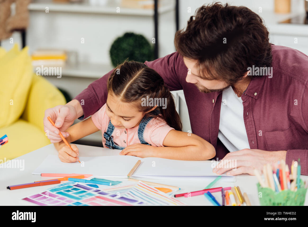 Father helping daughter in drawing hi-res stock photography and images ...