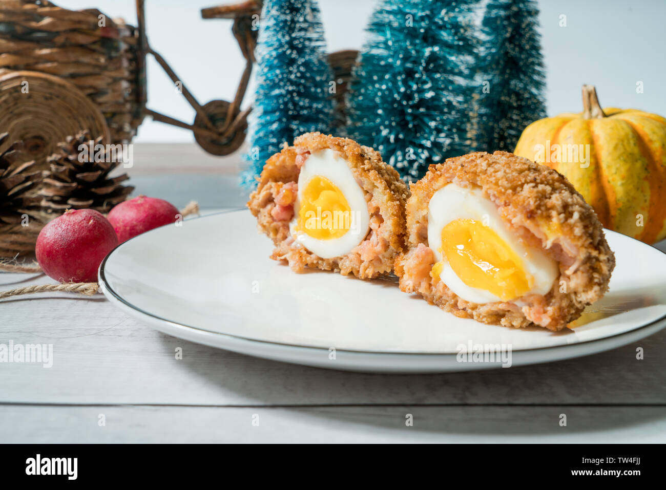Scottish egg pendulum plate with white background Stock Photo - Alamy