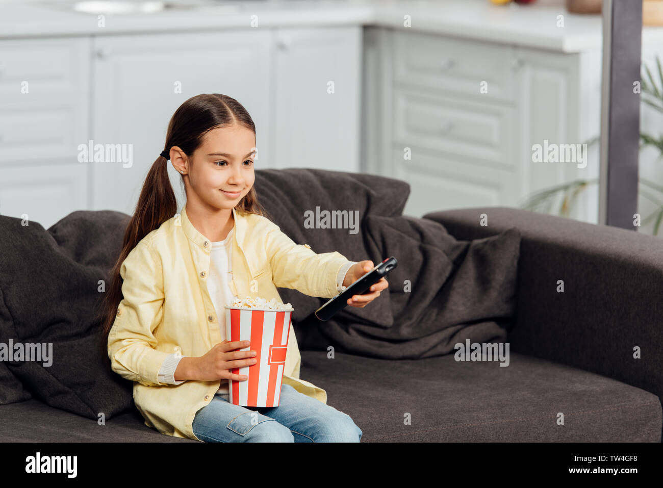 Kid holding remote hi-res stock photography and images - Alamy