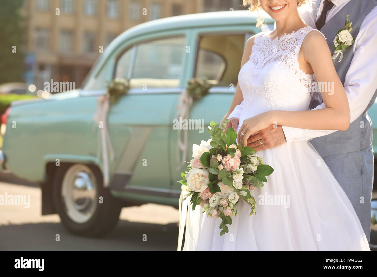 Happy wedding couple and decorated car on background Stock Photo - Alamy