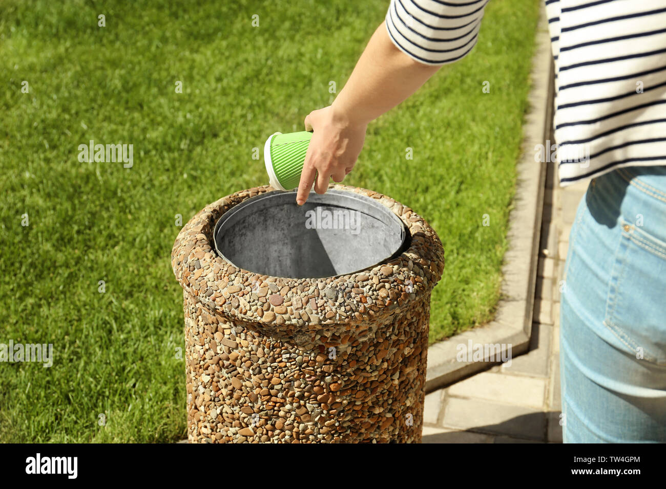 Person throwing trash grass hi-res stock photography and images - Alamy