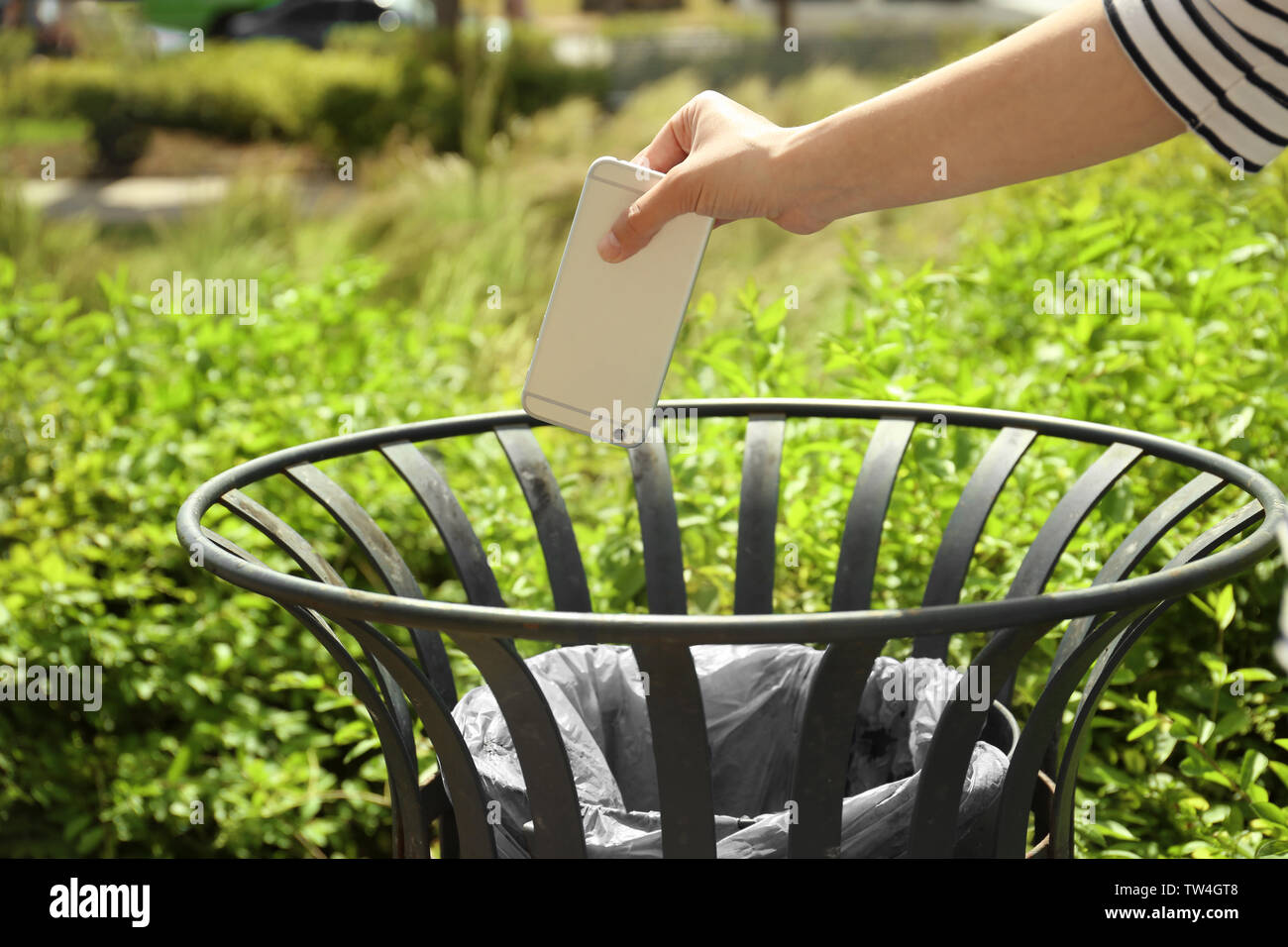 Woman throwing phone in bin hi-res stock photography and images - Alamy