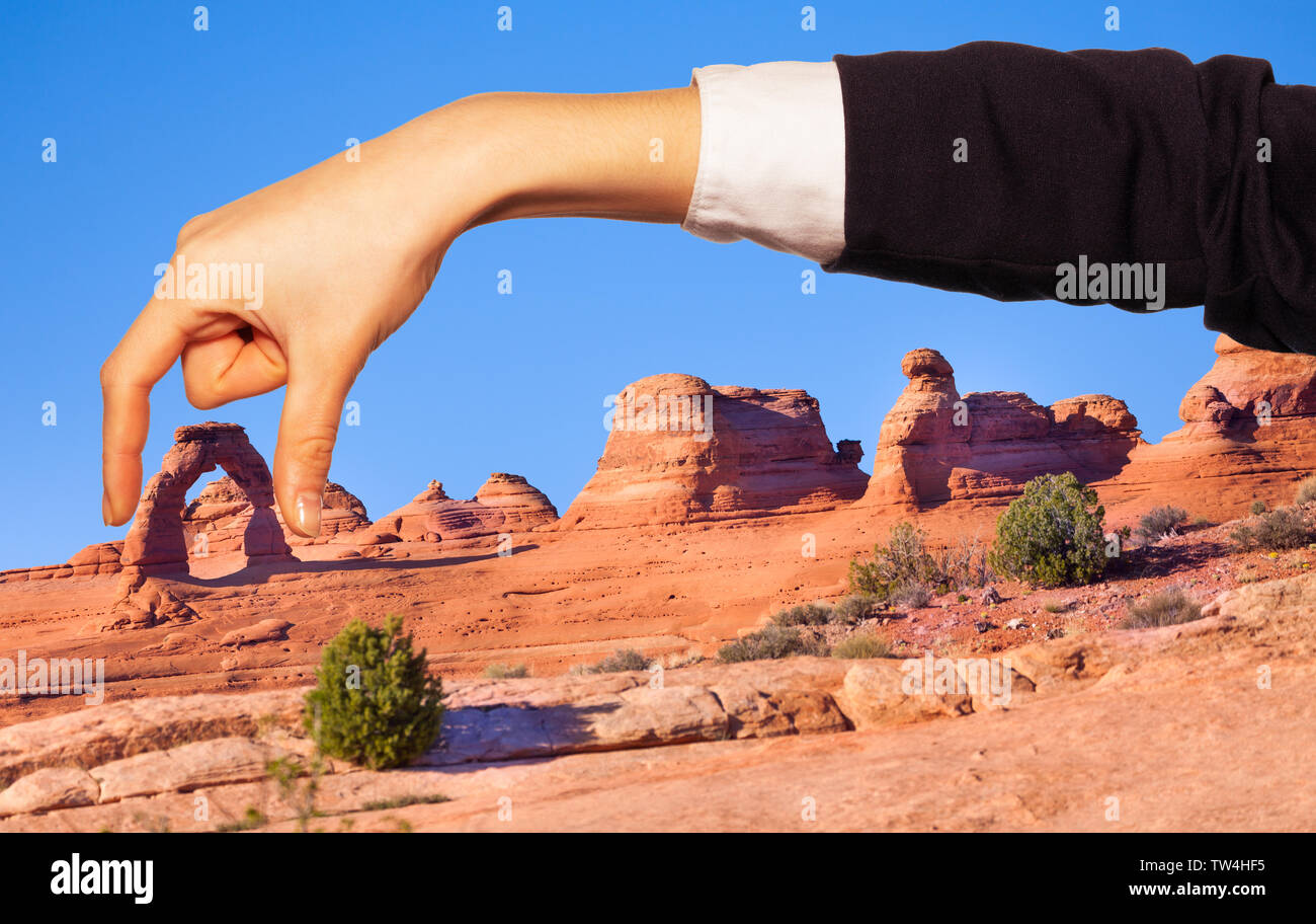 Woman's hand holding natural arch between fingers Stock Photo - Alamy