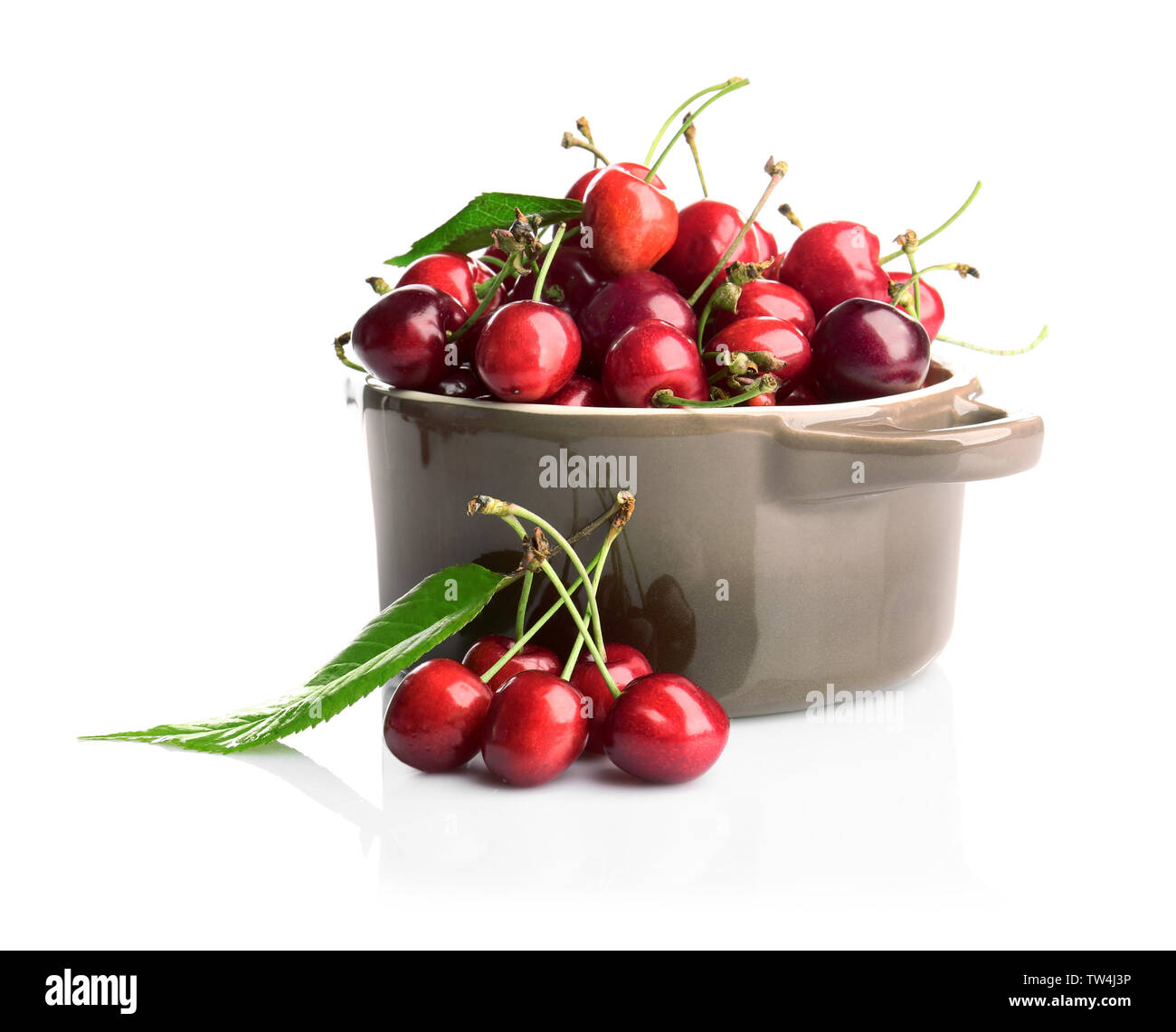 Pot with fresh ripe cherries on white background Stock Photo - Alamy