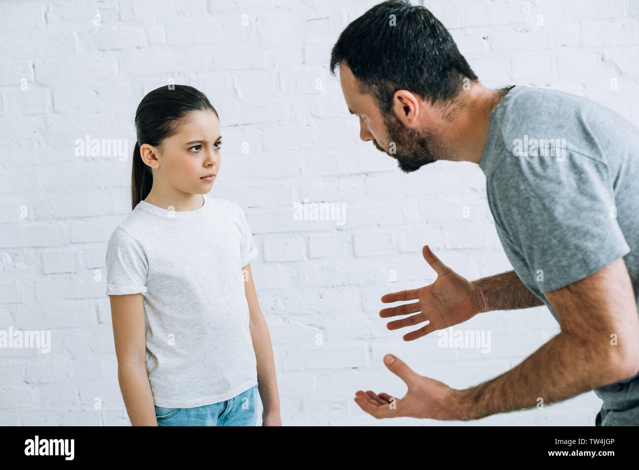 bearded angry father scolding upset daughter at home Stock Photo - Alamy