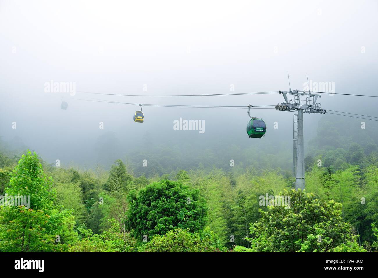 Cable car cableway up down the mountain with thick fog hi-res stock ...