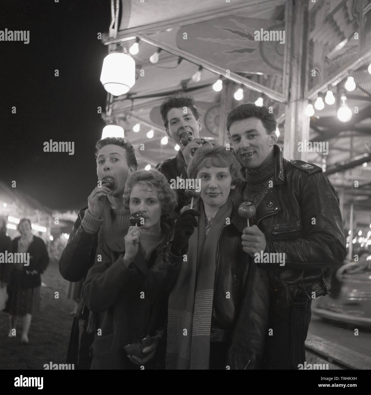 1960s, historical, young adults enjoying their toffee apples at an ...