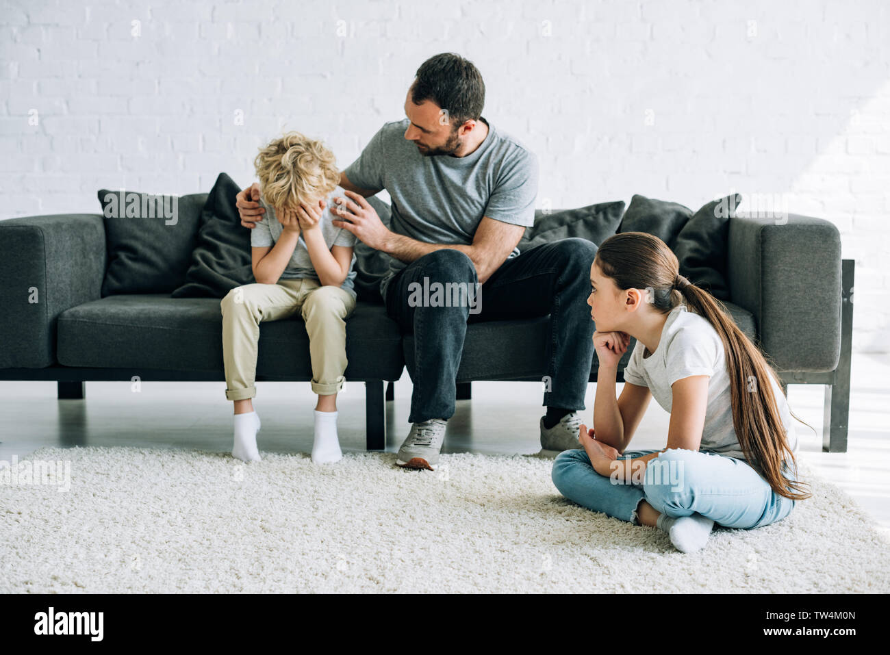 two sad preteen children and father having conflict Stock Photo - Alamy