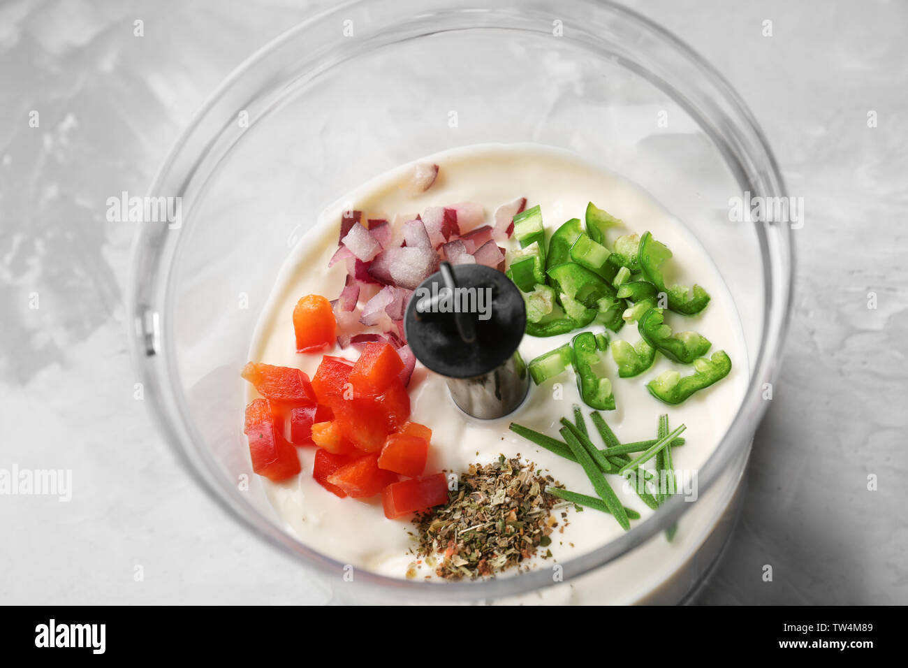 Blender bowl with ingredients for fish taco sauce on table Stock Photo ...