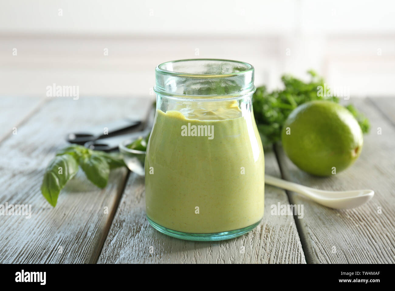 Tasty creamy lime mustard sauce for fish taco in glass jar on kitchen ...