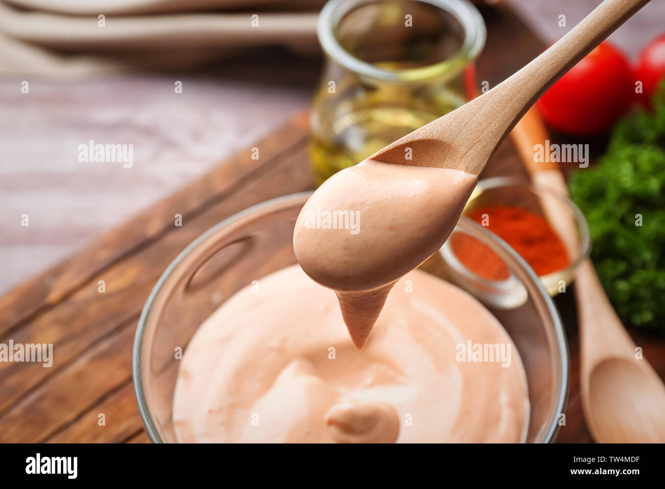 Spoon with tasty creamy sauce for fish taco over bowl, closeup Stock ...