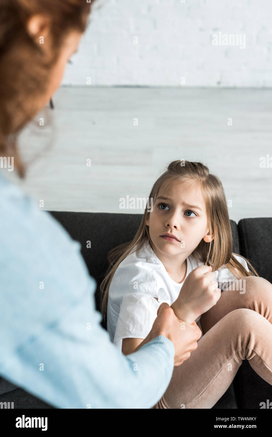 selective focus of scared kid looking at mother at home Stock Photo - Alamy