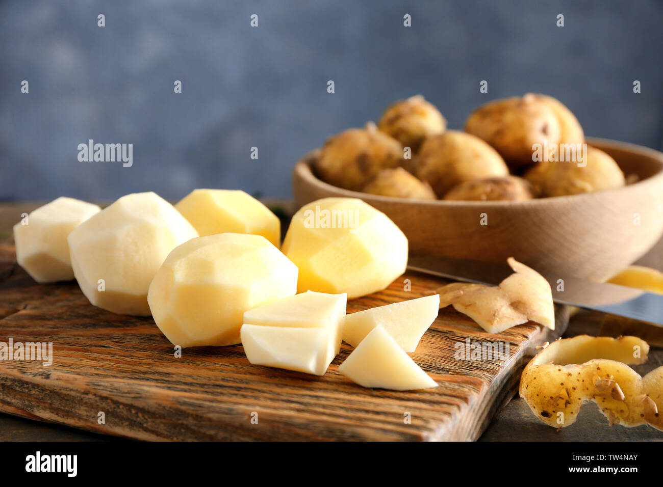Composition with peeled raw organic potatoes on table Stock Photo - Alamy