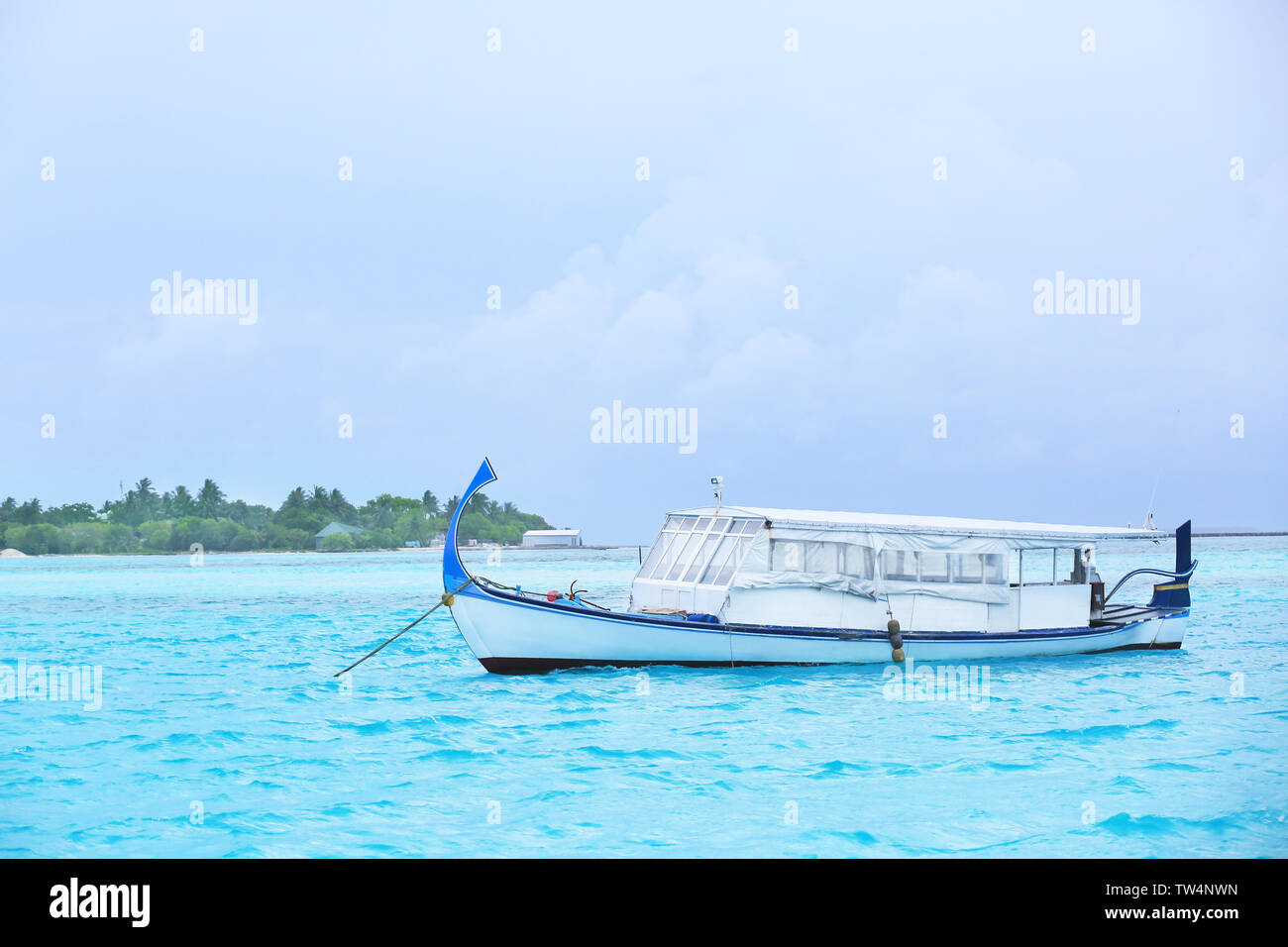 Modern boat berthed at tropical resort Stock Photo - Alamy