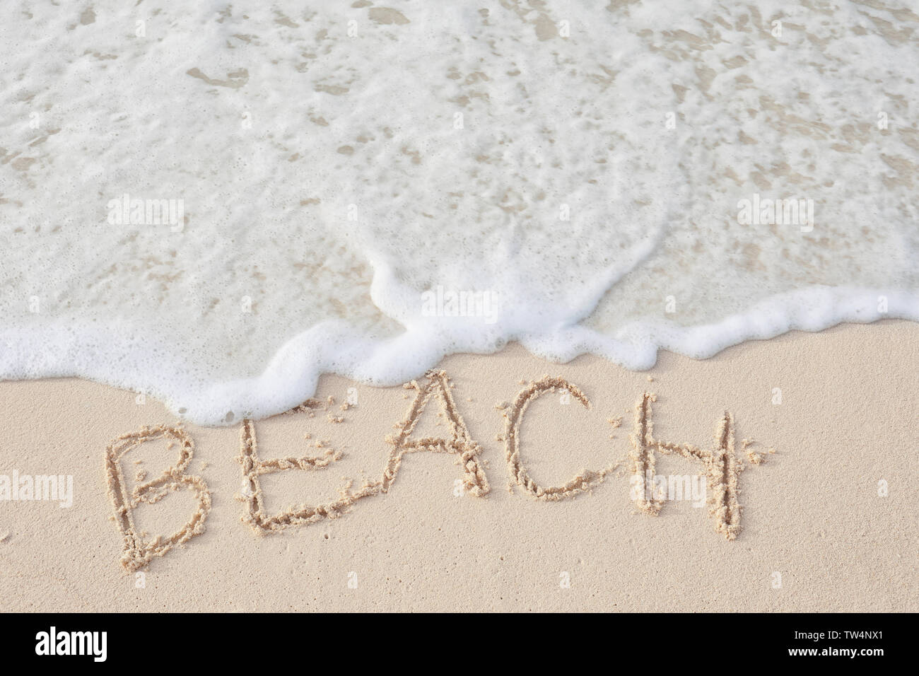 Word BEACH on sand at sea resort. Summer vacation concept Stock Photo ...