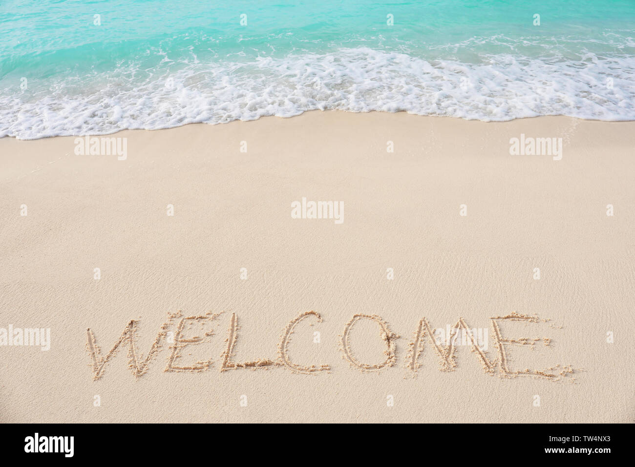 Word WELCOME on beach sand. Summer vacation concept Stock Photo - Alamy