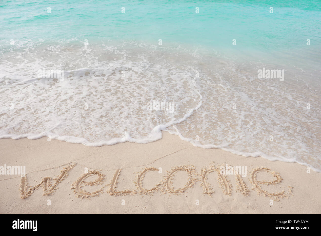 Word WELCOME on beach sand. Summer vacation concept Stock Photo - Alamy