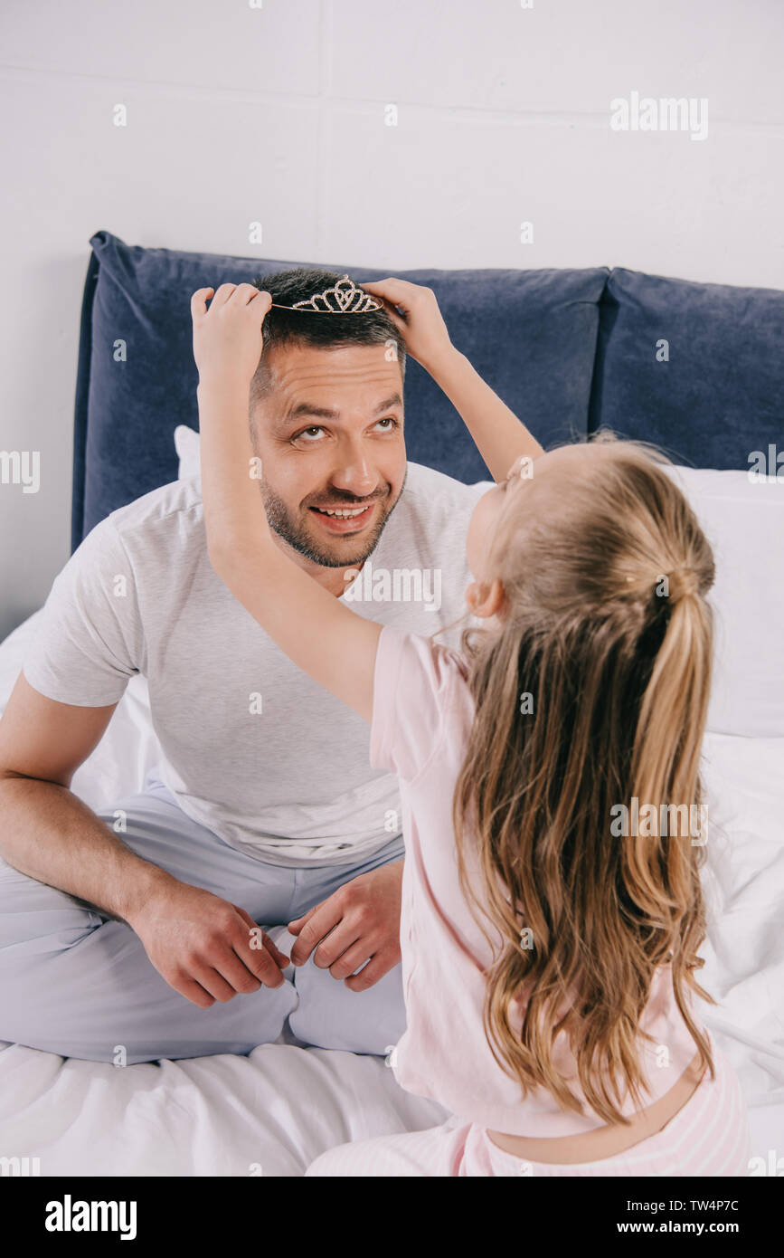 Girl putting on crown hi-res stock photography and images - Alamy