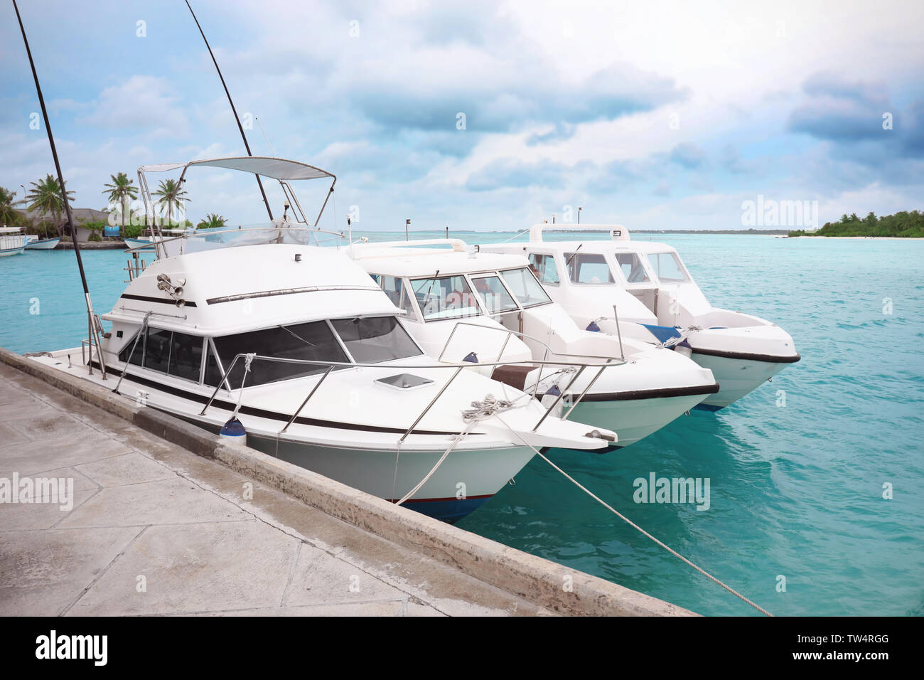 Berth with modern boats at tropical resort Stock Photo - Alamy