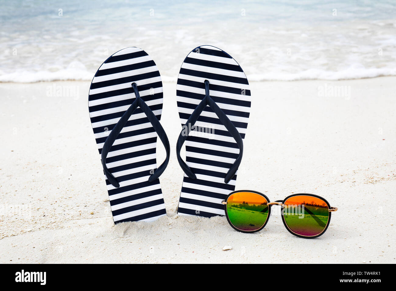 Flip-flops and sunglasses on beach sand. Summer vacation concept Stock ...