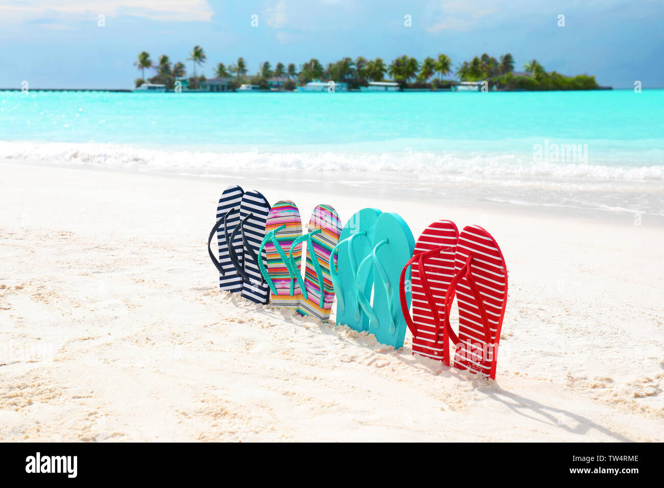 Colorful flip-flops on sea beach. Summer vacation concept Stock Photo ...