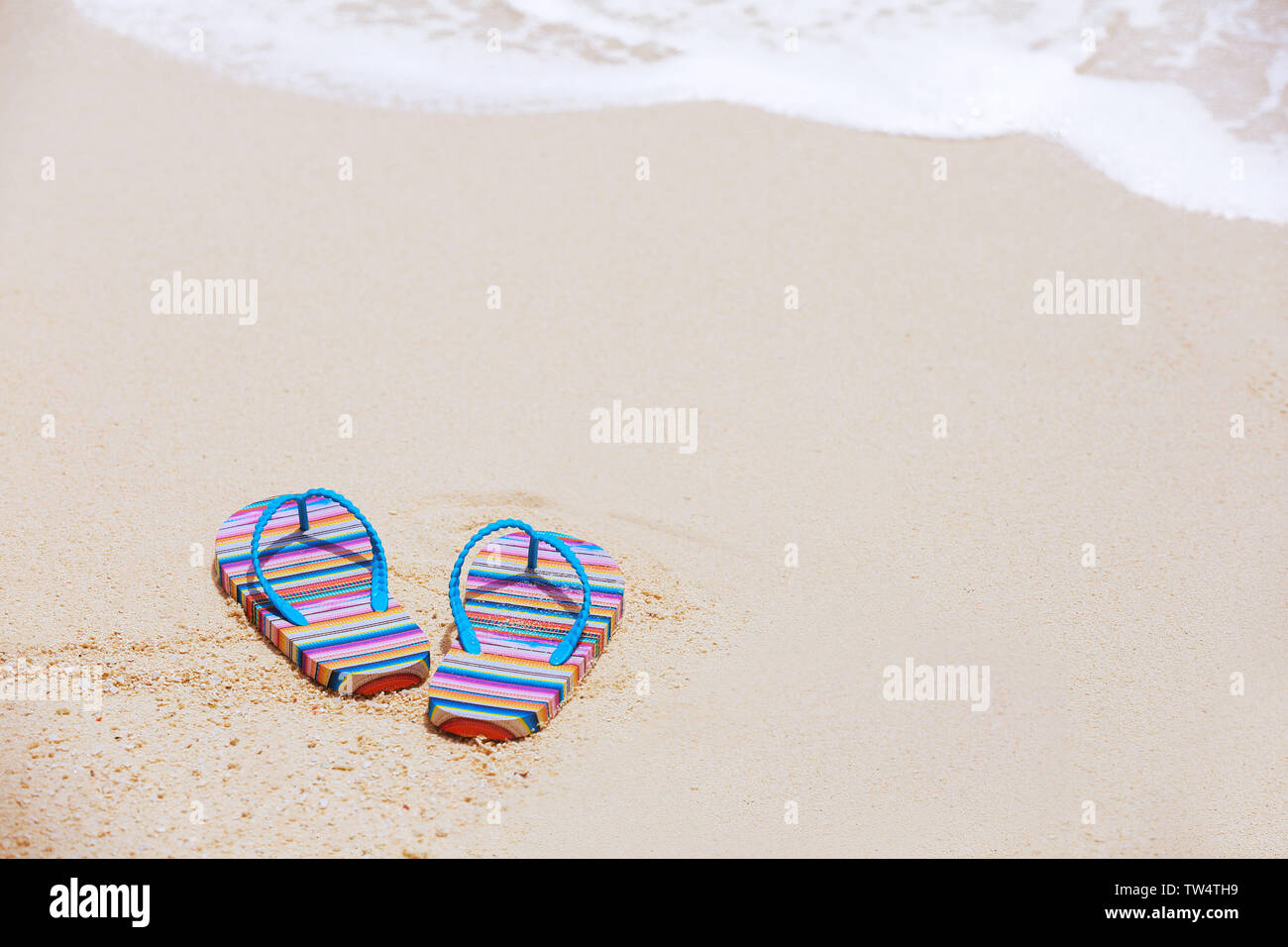 Flip-flops on beach sand. Summer vacation concept Stock Photo - Alamy
