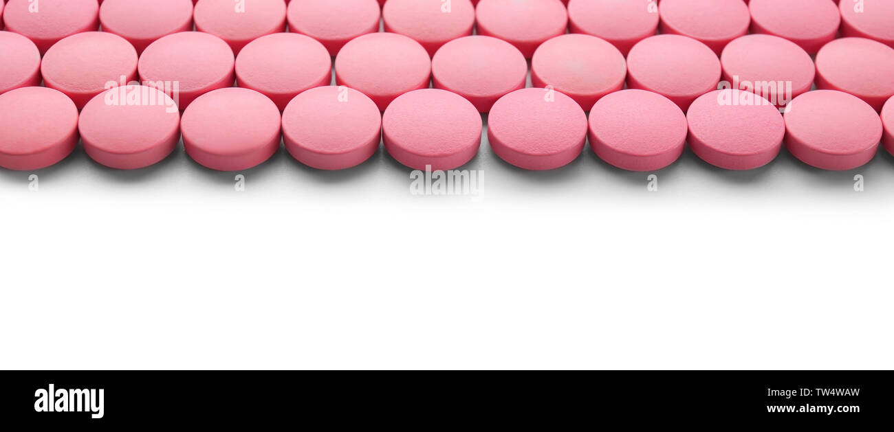 Color round pills on white background Stock Photo - Alamy