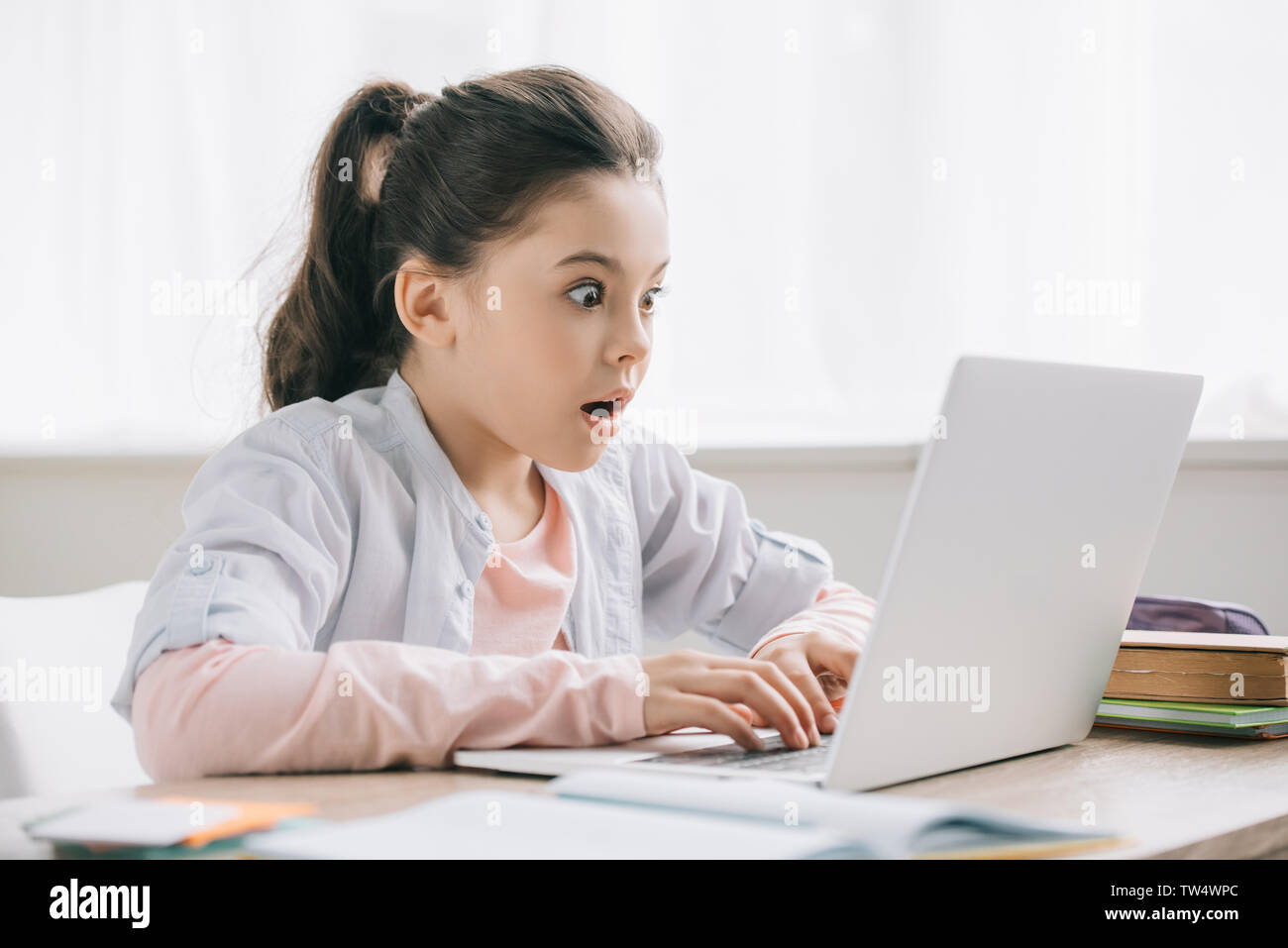 Shocked schoolgirl sitting laptop hi-res stock photography and images ...