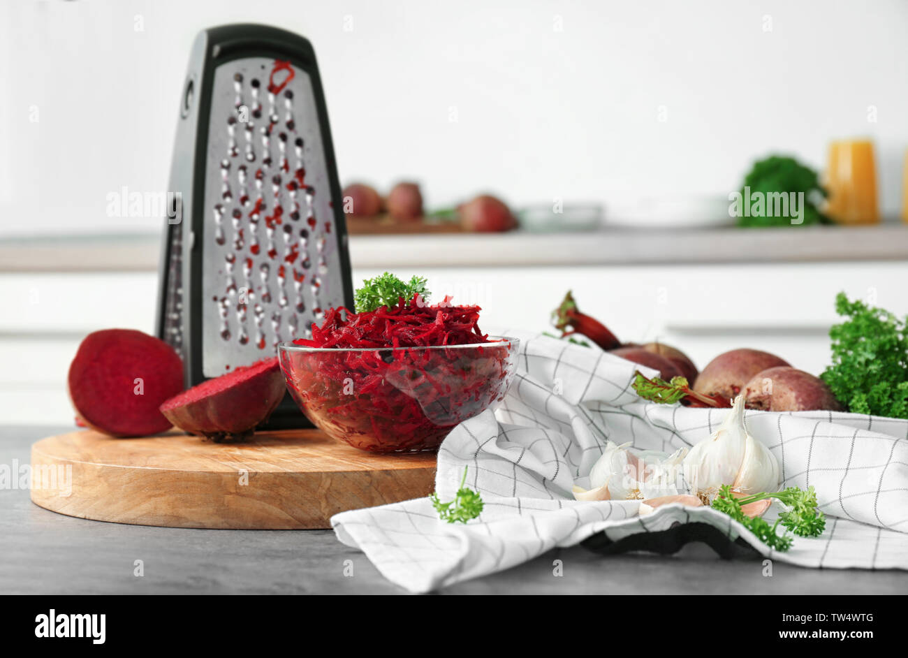 Fresh beetroot and grater on table in kitchen Stock Photo - Alamy