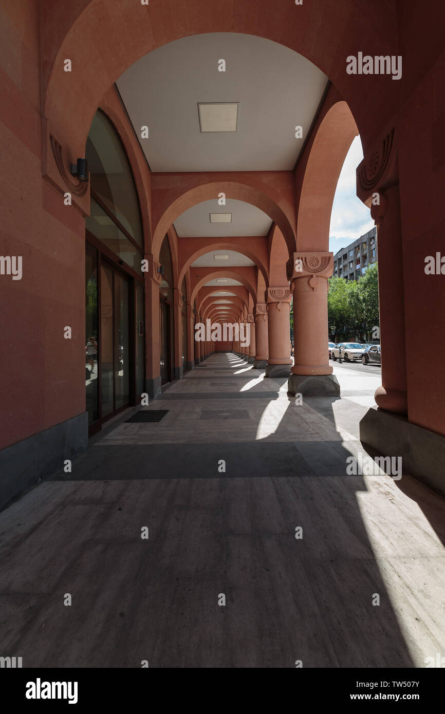 modern columns of a building on the street adhering to the peak from ...