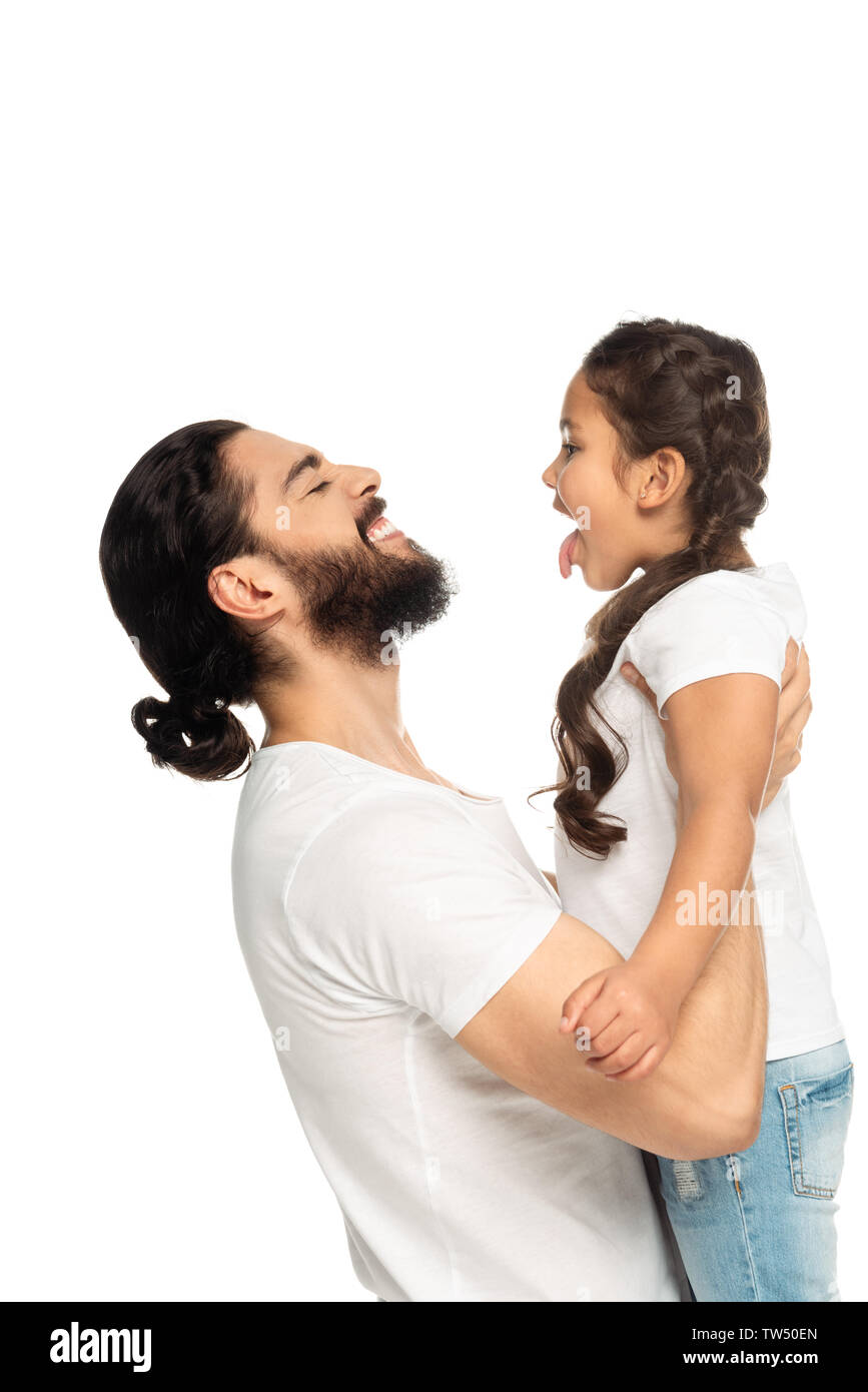 happy latin father smiling while holding in arms cute daughter showing ...