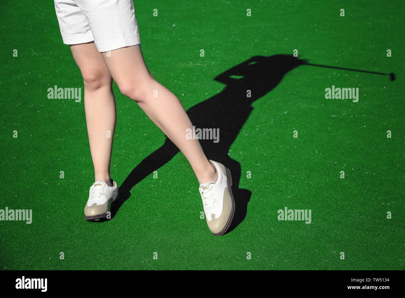 Female's legs in golf shoes at course Stock Photo - Alamy