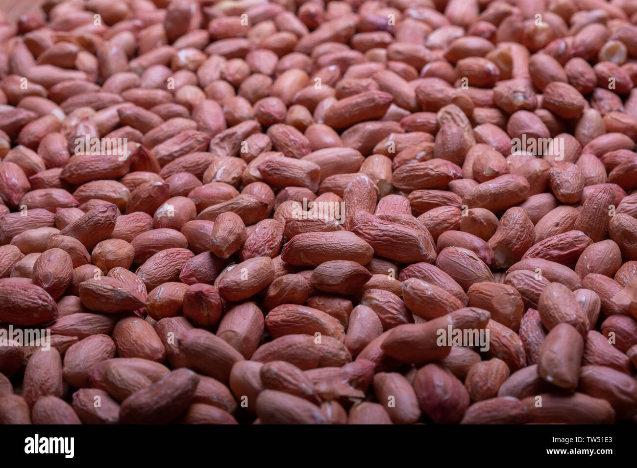 peanuts scattered on a wooden table. Close-up peanuts beans. Nut ...
