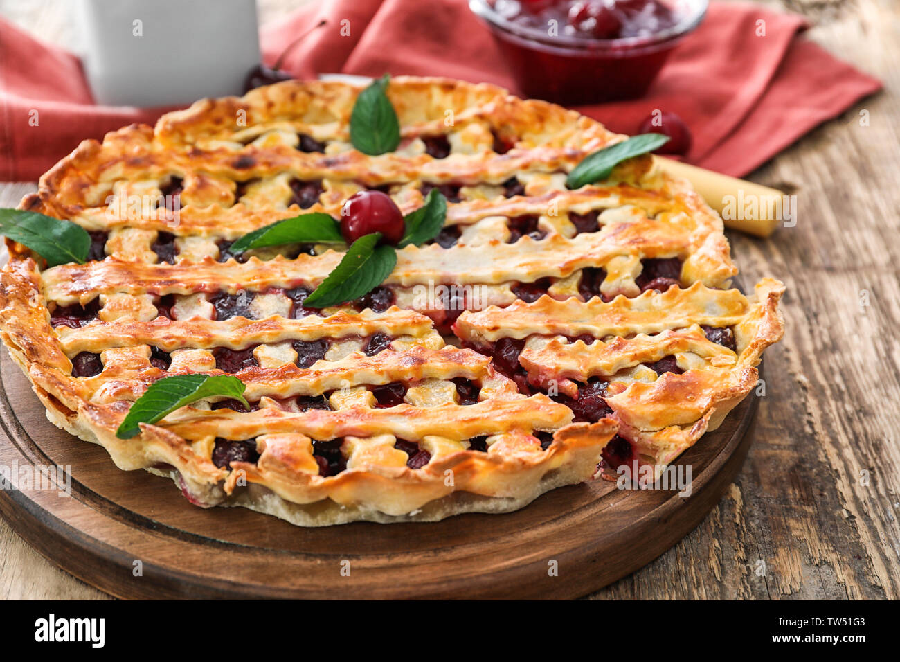 Delicious cherry pie on kitchen table Stock Photo - Alamy