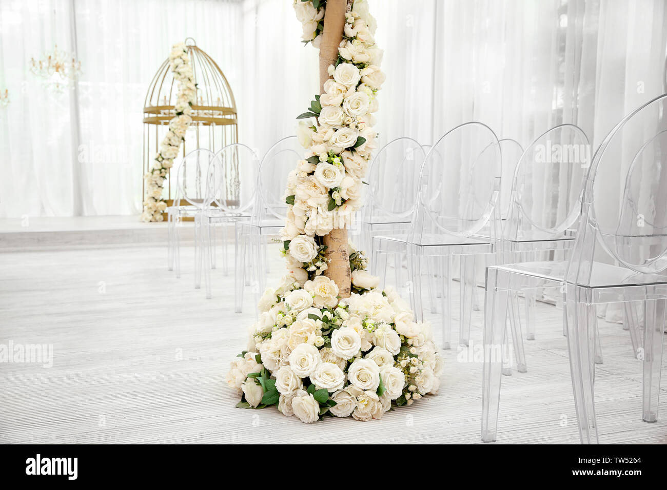 Tree decorated with beautiful flowers in wedding hall Stock Photo - Alamy