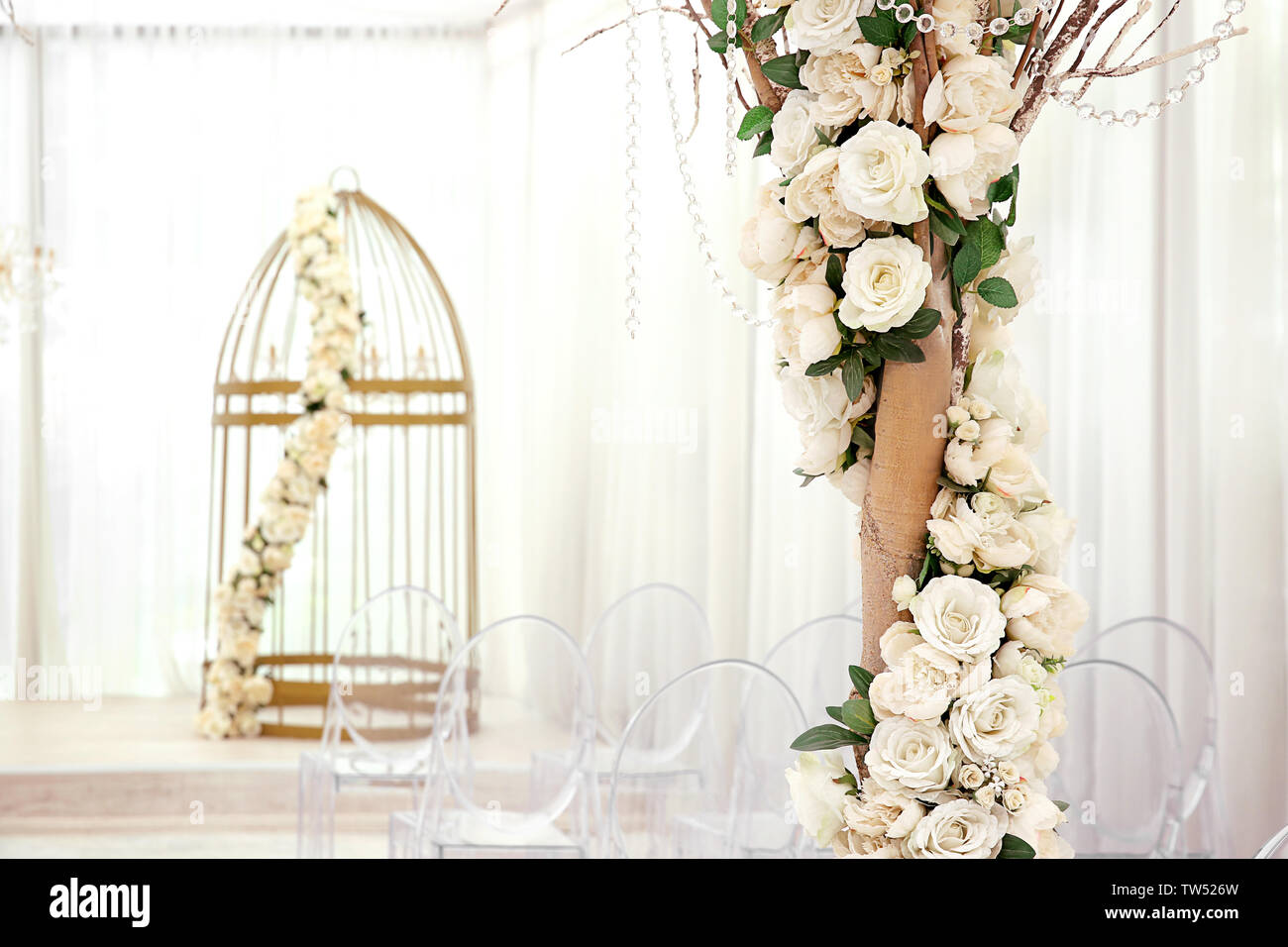 Tree decorated with beautiful flowers in wedding hall Stock Photo - Alamy