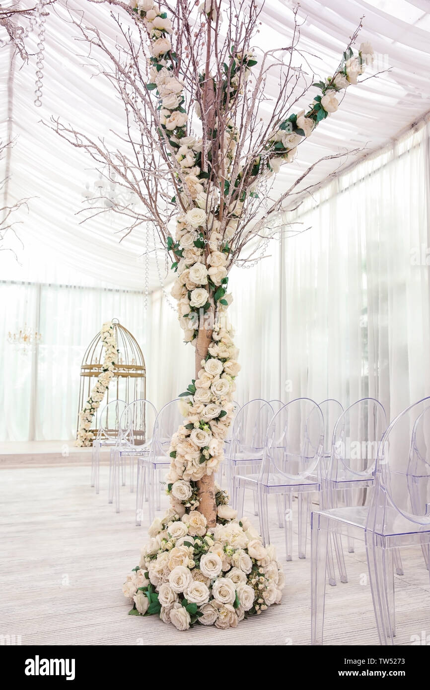 Tree decorated with beautiful flowers in wedding hall Stock Photo - Alamy