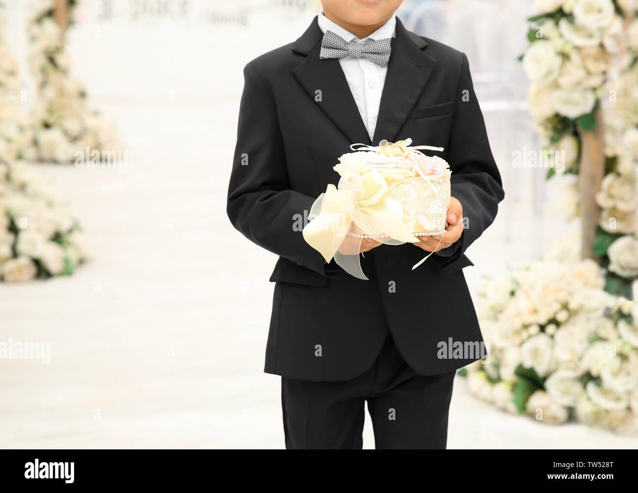 Cute little boy holding box with rings on wedding day, indoors Stock ...