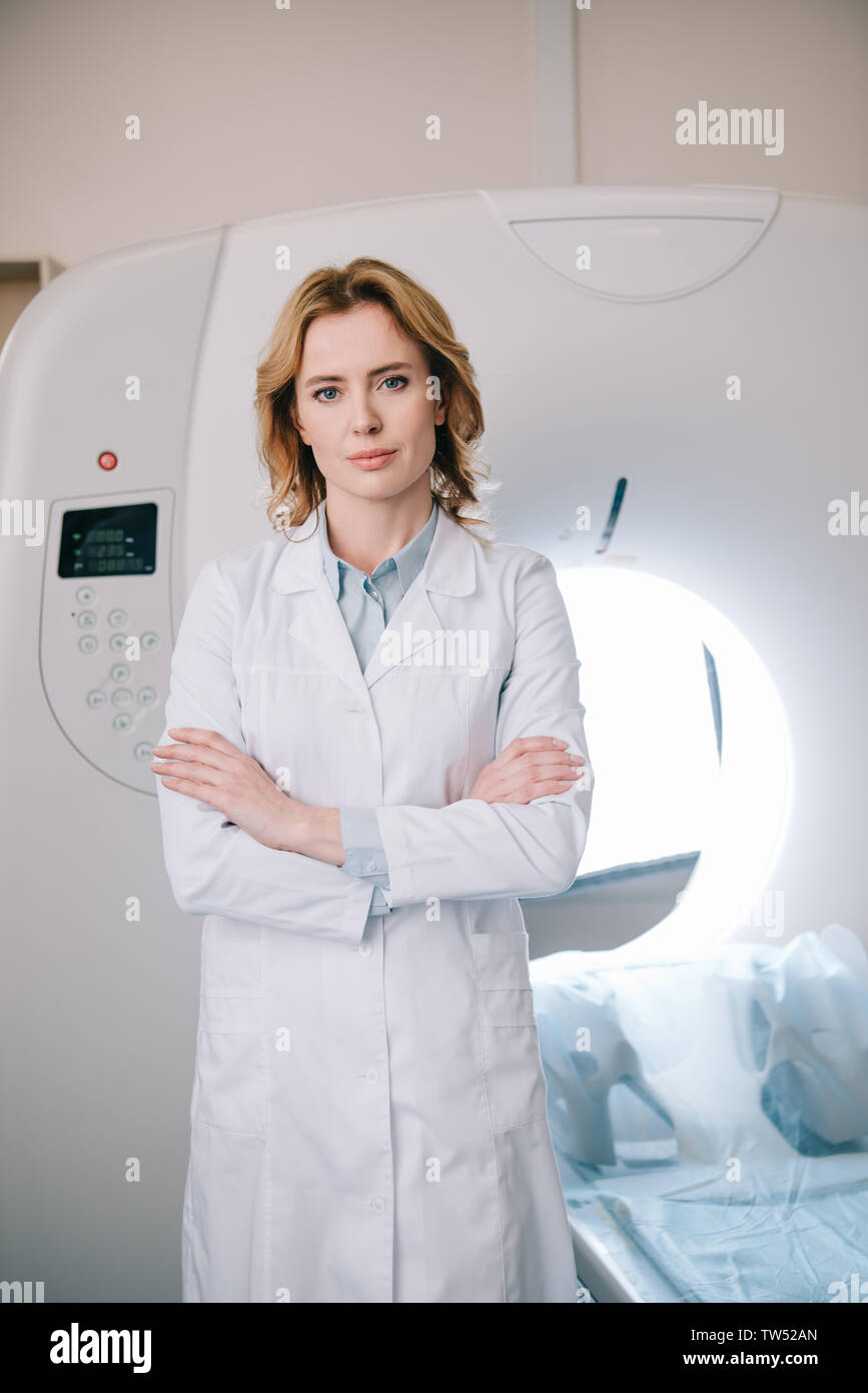 beautiful radiologist standing near ct scanner with crossed arms and ...