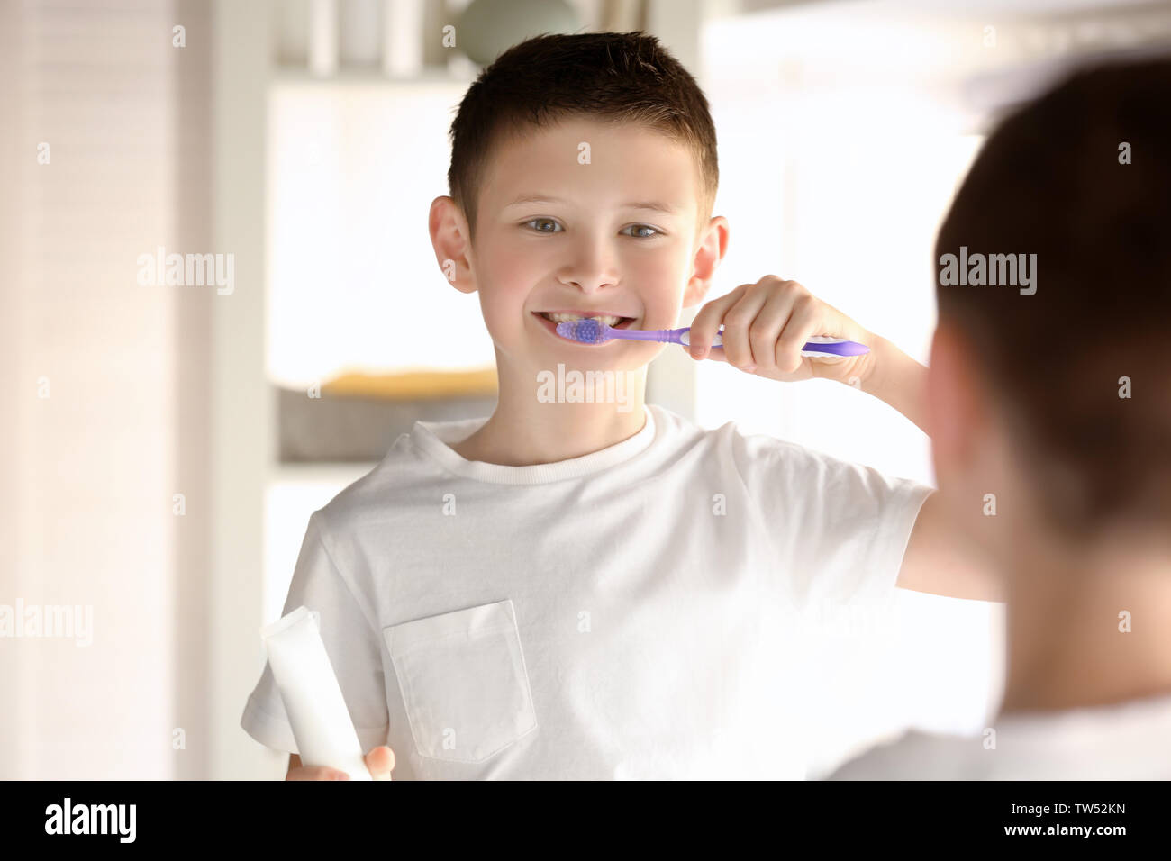 Cute little boy cleaning teeth at home Stock Photo - Alamy