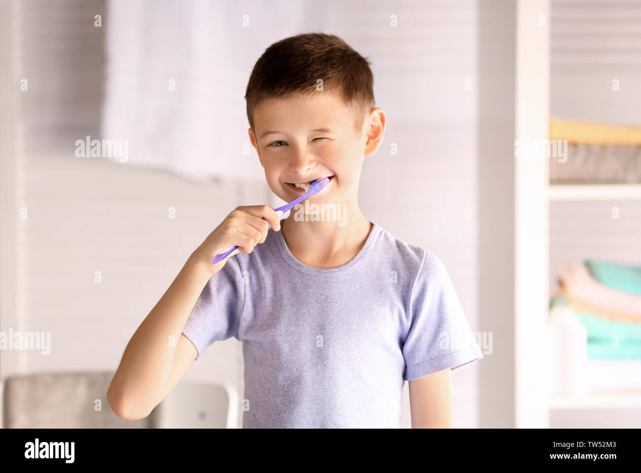 Cute little boy cleaning teeth at home Stock Photo - Alamy