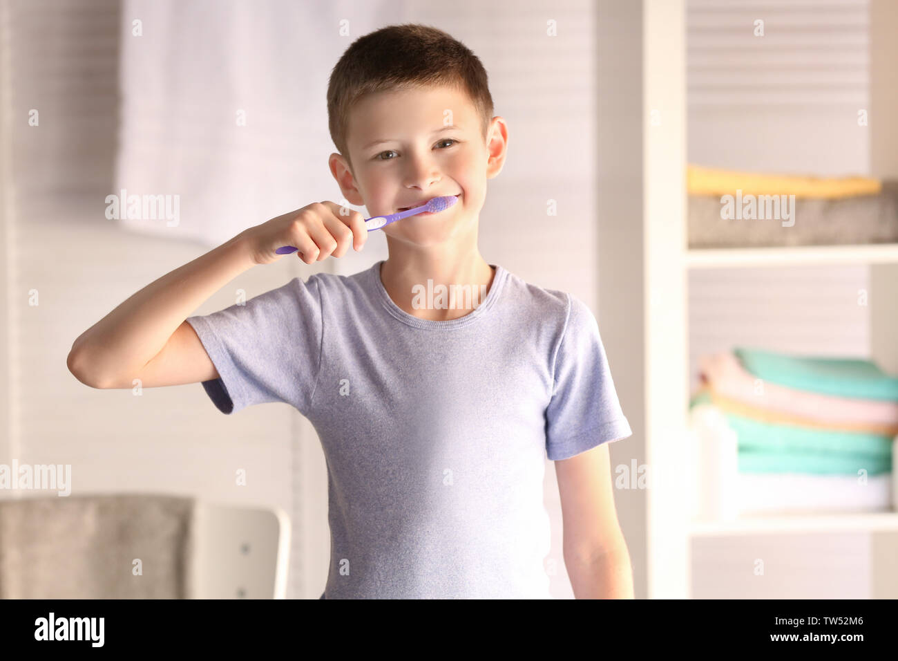 Cute little boy cleaning teeth at home Stock Photo - Alamy