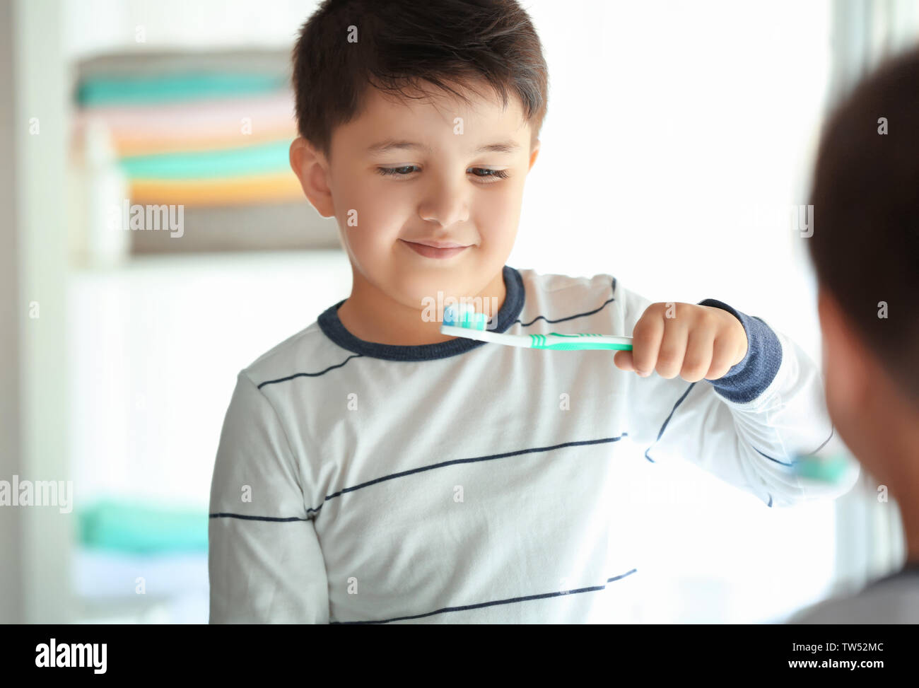 Cute little boy cleaning teeth at home Stock Photo - Alamy