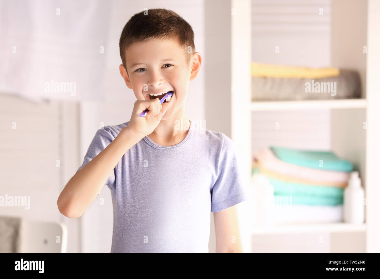 Cute little boy cleaning teeth at home Stock Photo - Alamy