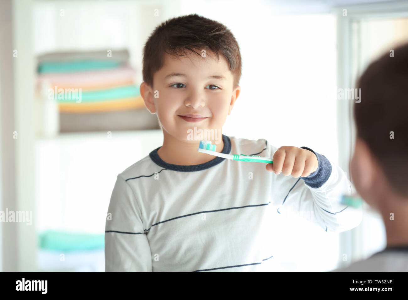 Cute little boy cleaning teeth at home Stock Photo - Alamy