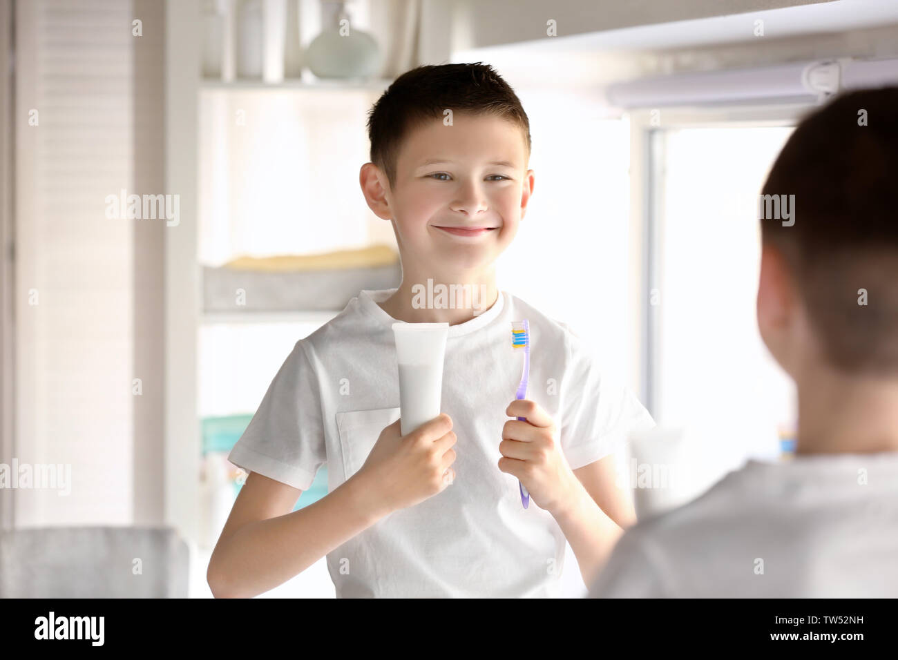 Cute little boy with toothbrush and paste at home. Cleaning teeth ...