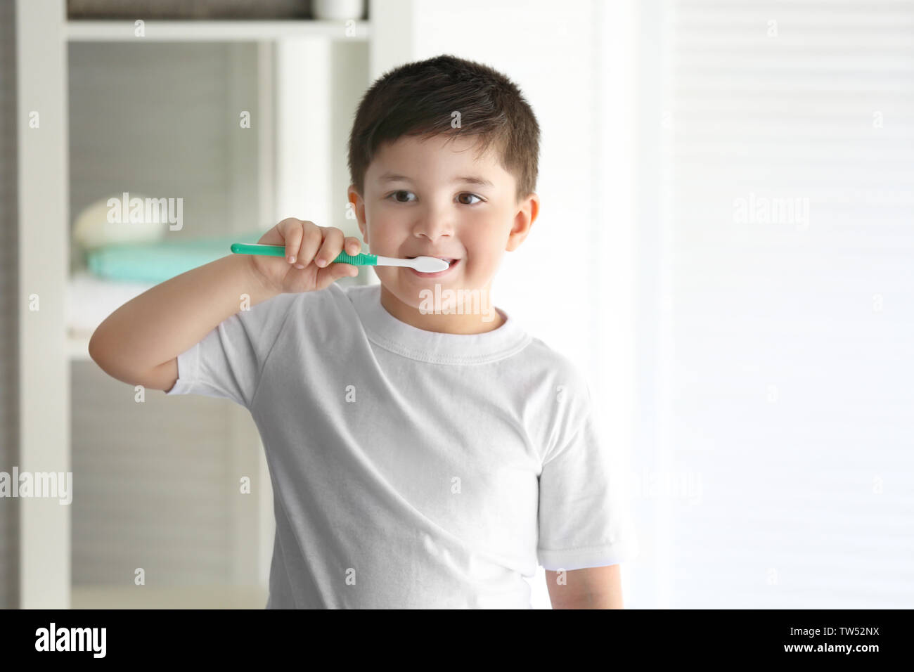 Cute little boy cleaning teeth at home Stock Photo - Alamy