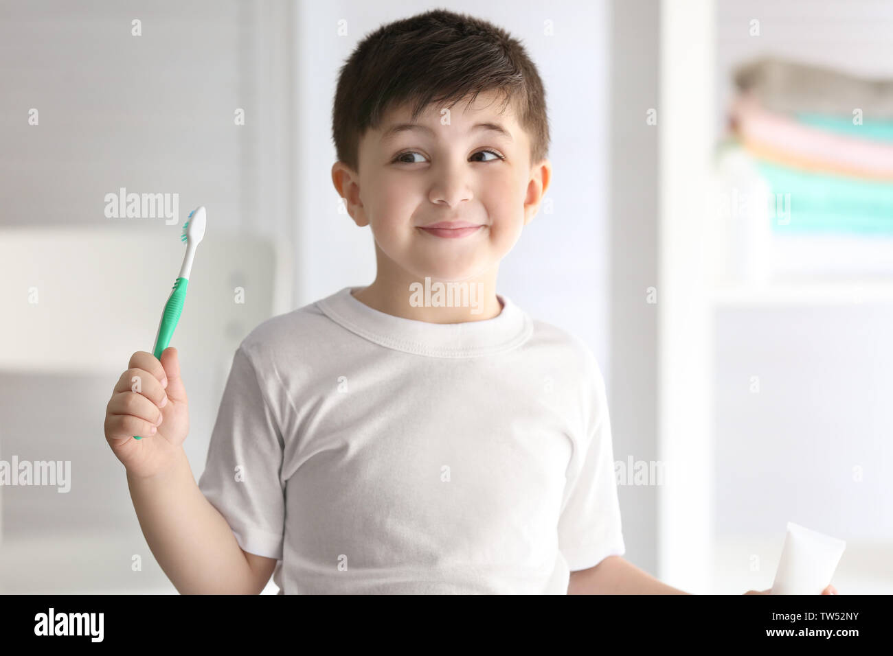 Cute little boy with toothbrush and paste at home. Cleaning teeth ...